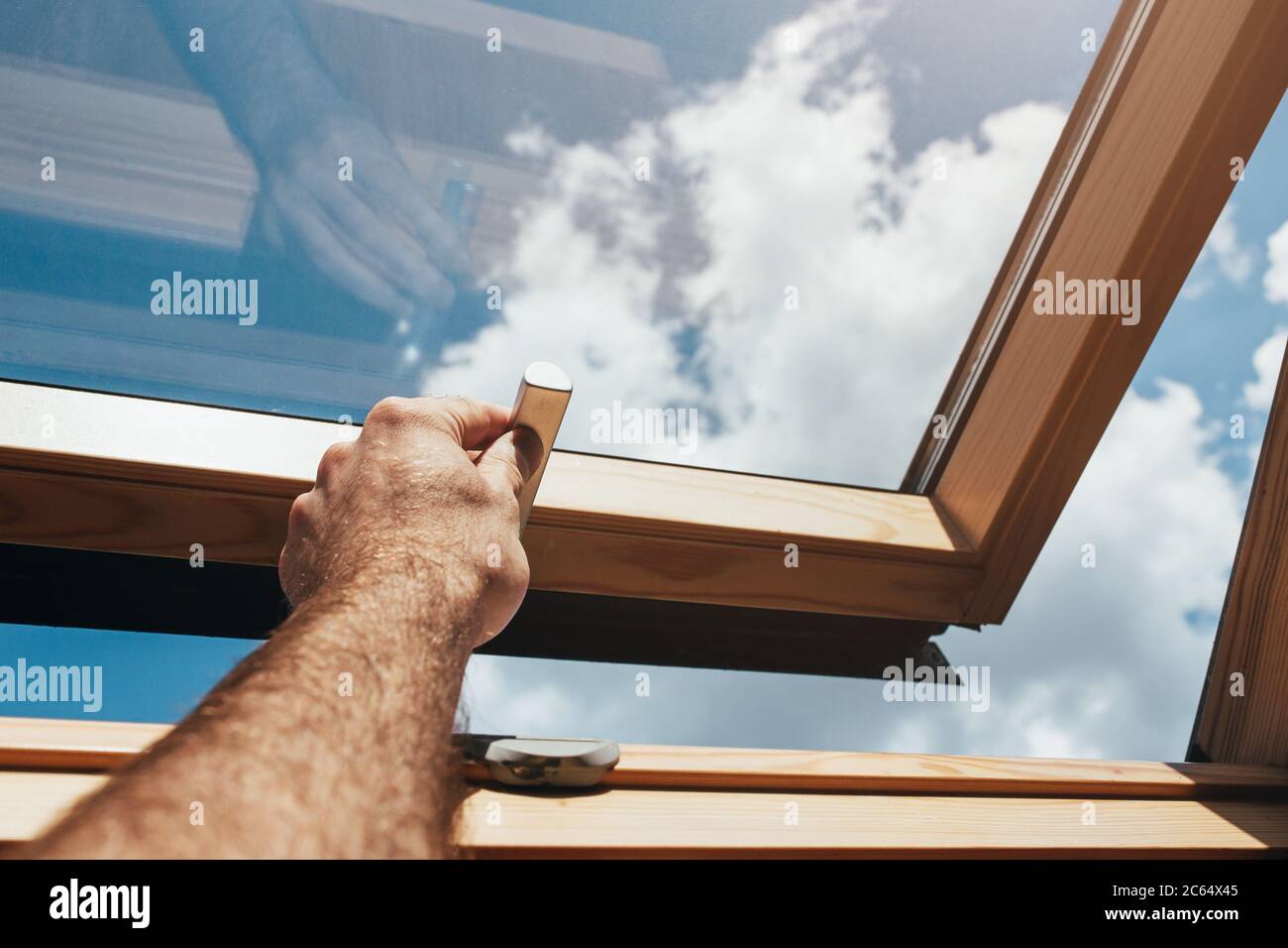 The hand opens a dormer-window for airing - early morning freshness and ...