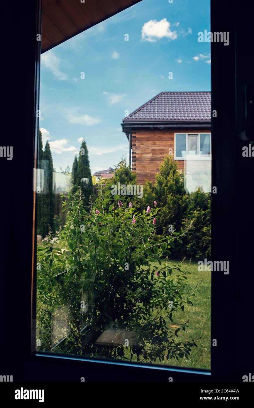 Country real estate - view from the window to the courtyard with grass ...