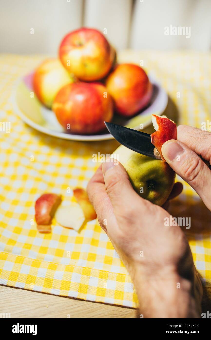 Close-up hands while peeling apple peel - ingredient for fruit cake ...