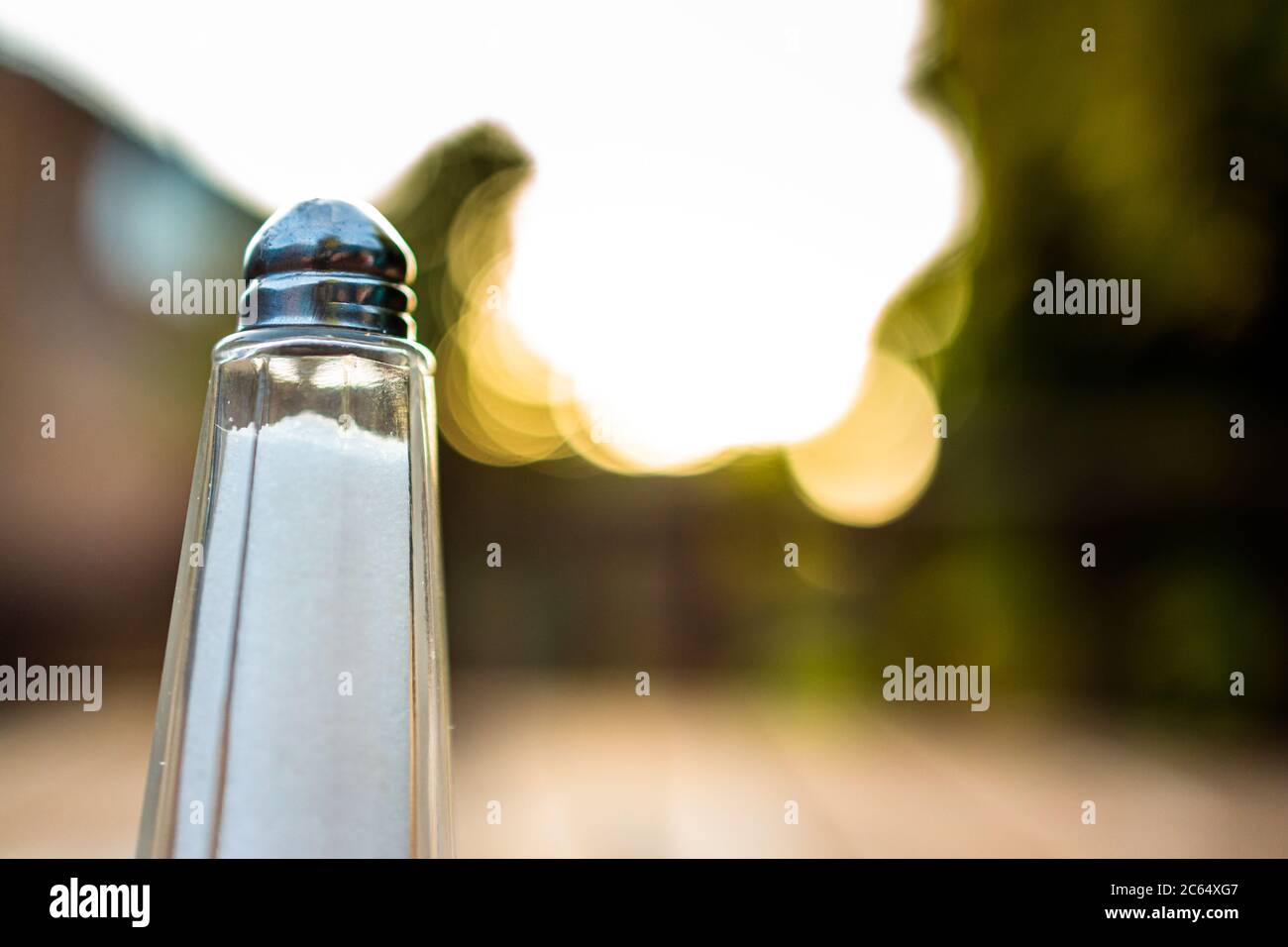 Salt shaker up close with copy space Stock Photo - Alamy