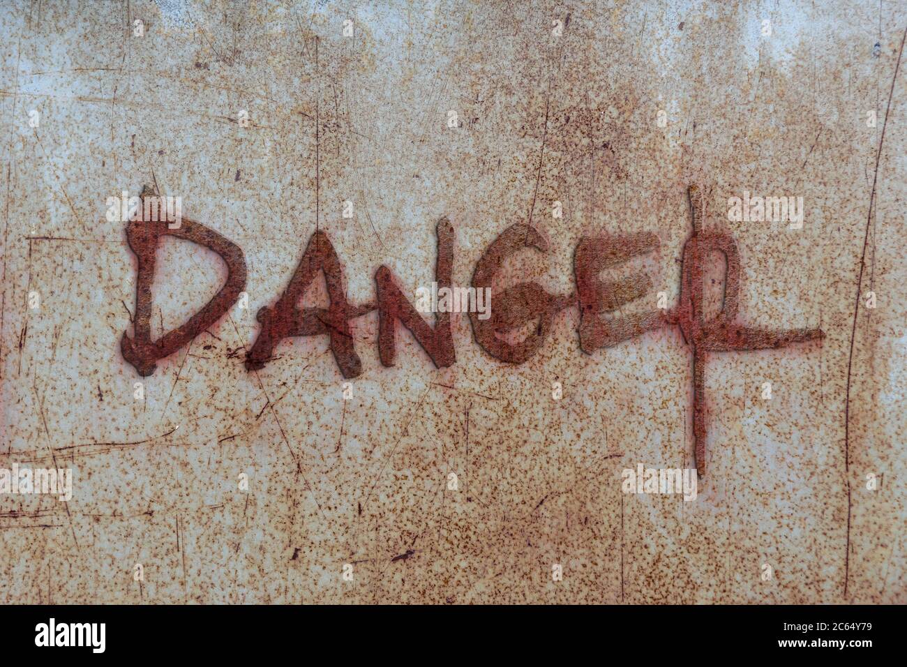 The inscription warning of the danger. Old metal texture Stock Photo ...
