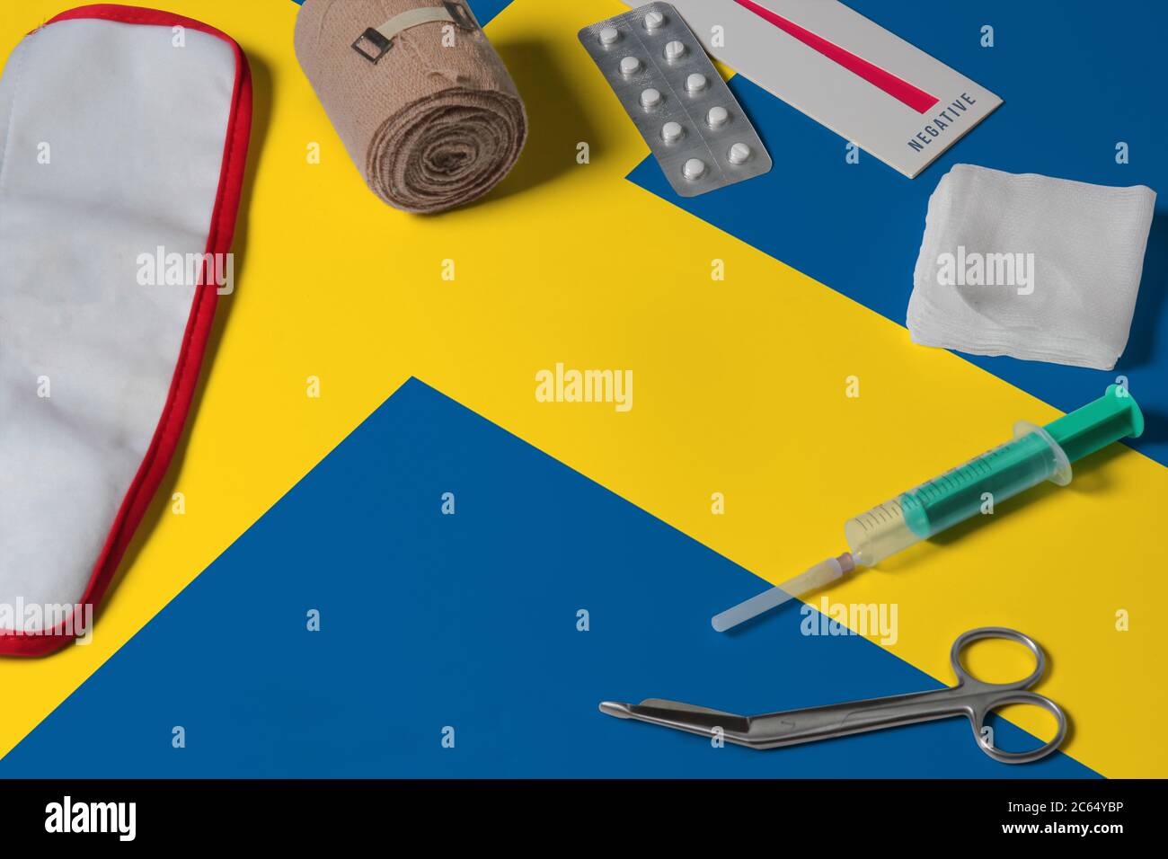 Sweden flag with first aid medical kit on wooden table background ...