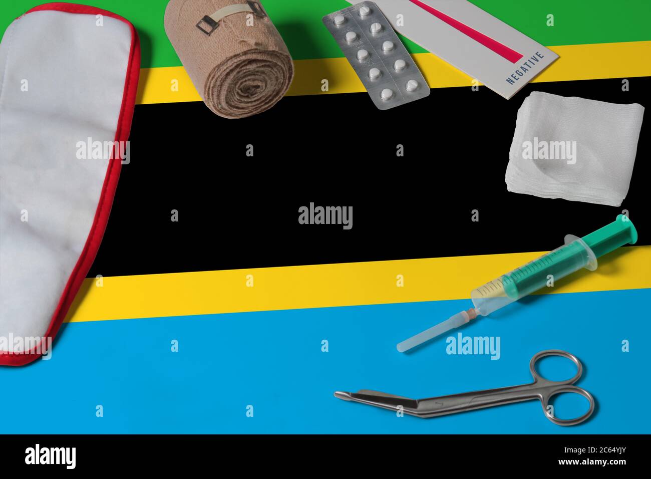 Tanzania flag with first aid medical kit on wooden table background ...
