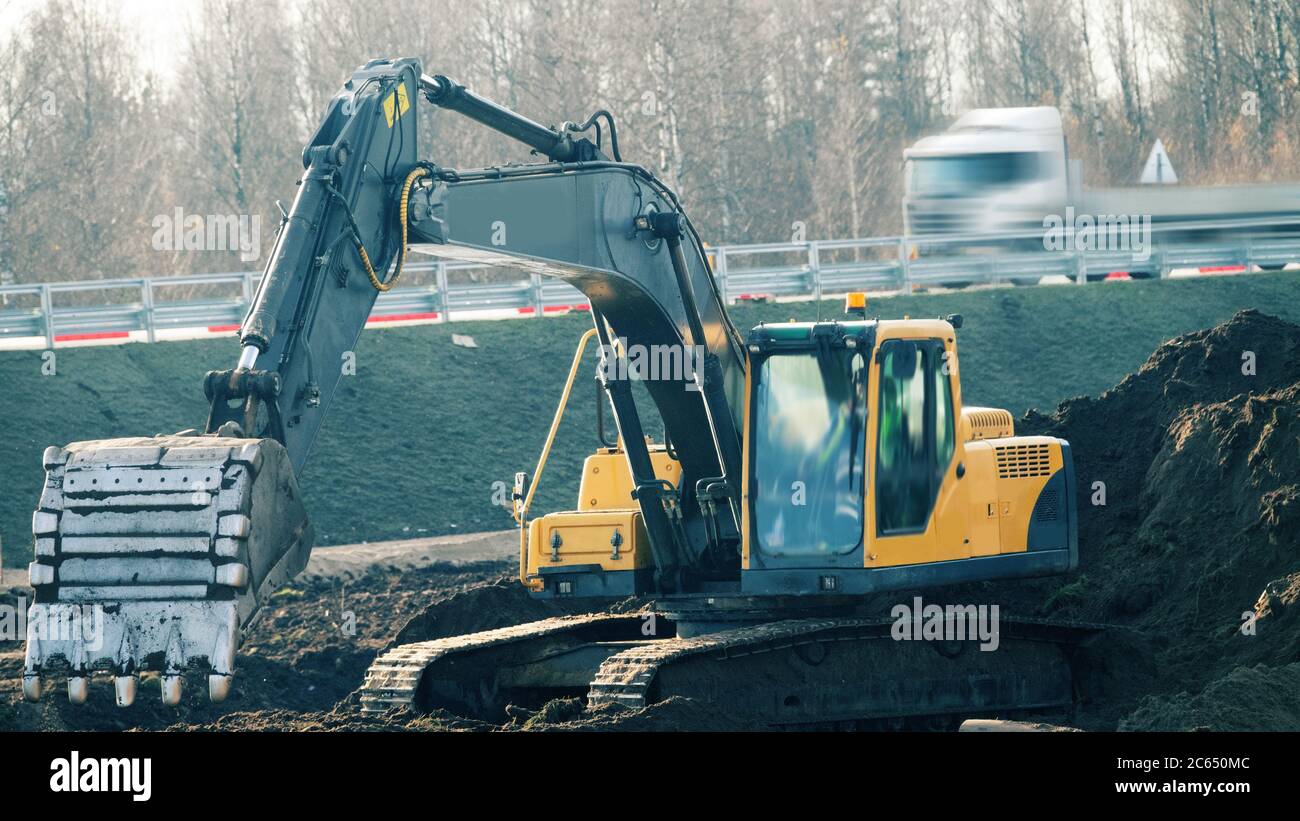 Construction of the highway. The work of earthmoving equipment ...