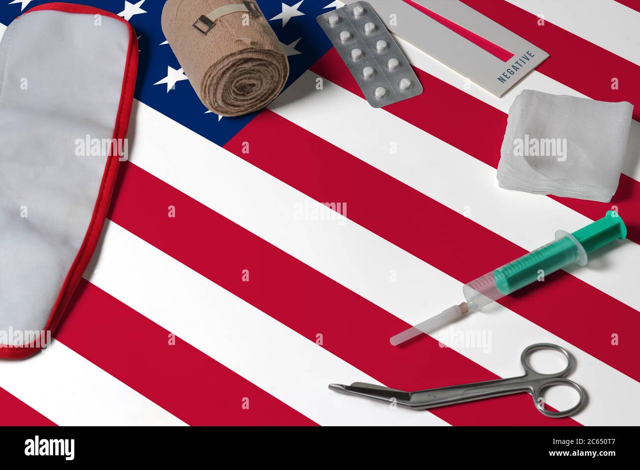 United States flag with first aid medical kit on wooden table ...