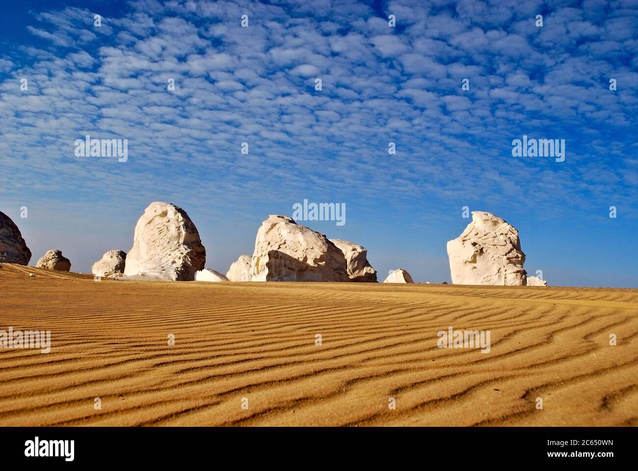 The limestone formation in White Desert and the waves of a golden sand ...