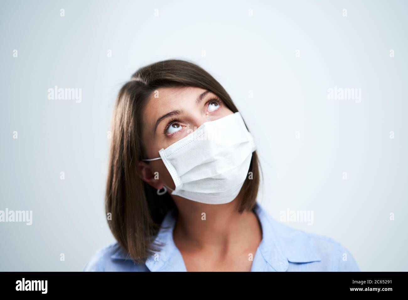 Attractive woman wearing protective mask isolated over white background ...