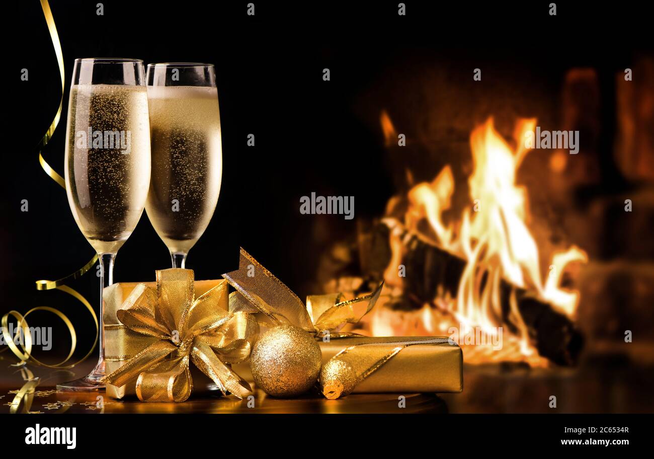 Celebration toast with champagne. Two champagne flutes with gold gift ...