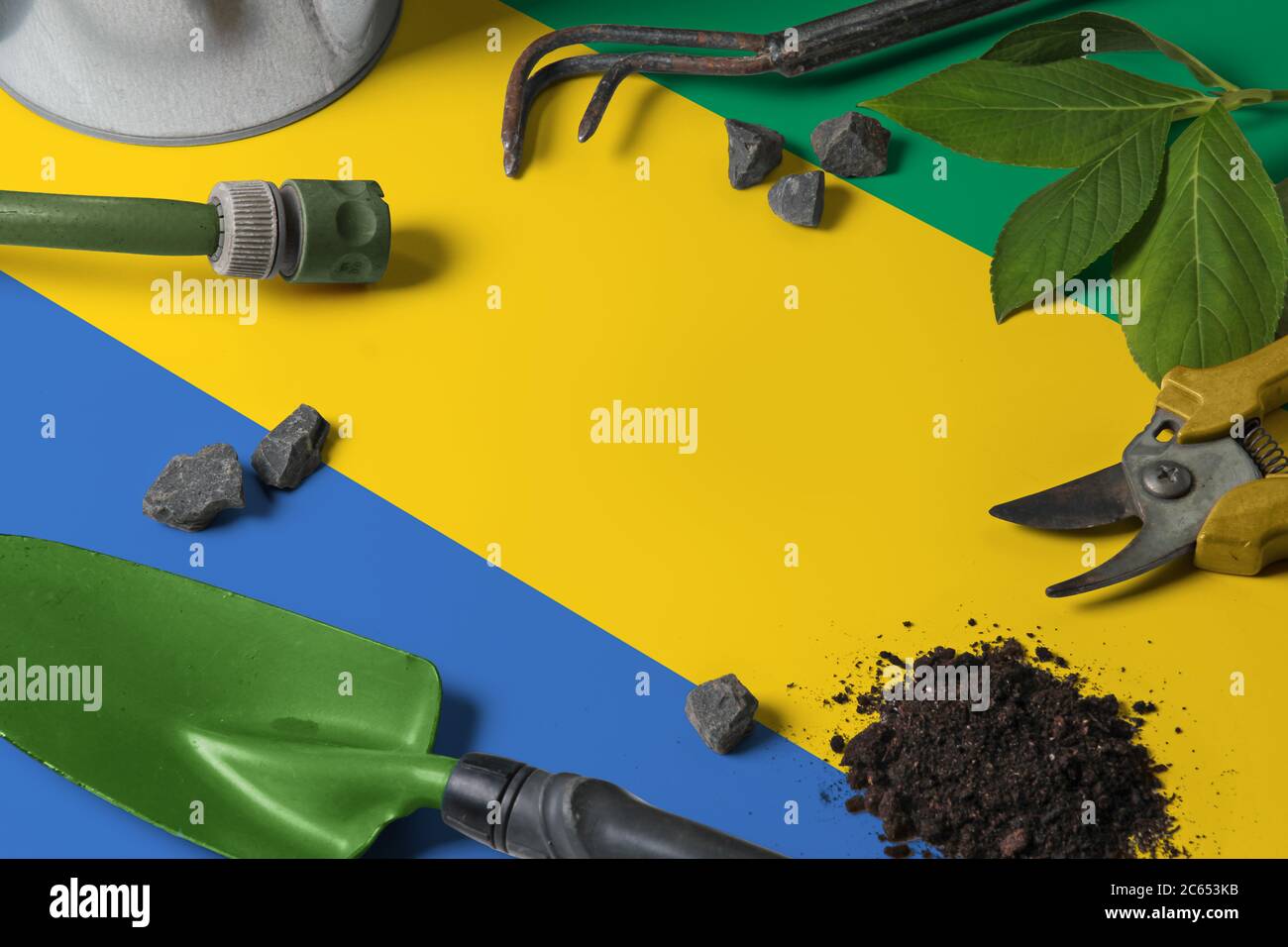 Gabon flag with gardening tools background on table. Spring in the ...