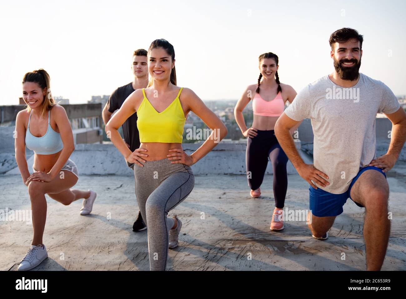 Group of happy fit people friends exercising together outdoor Stock ...