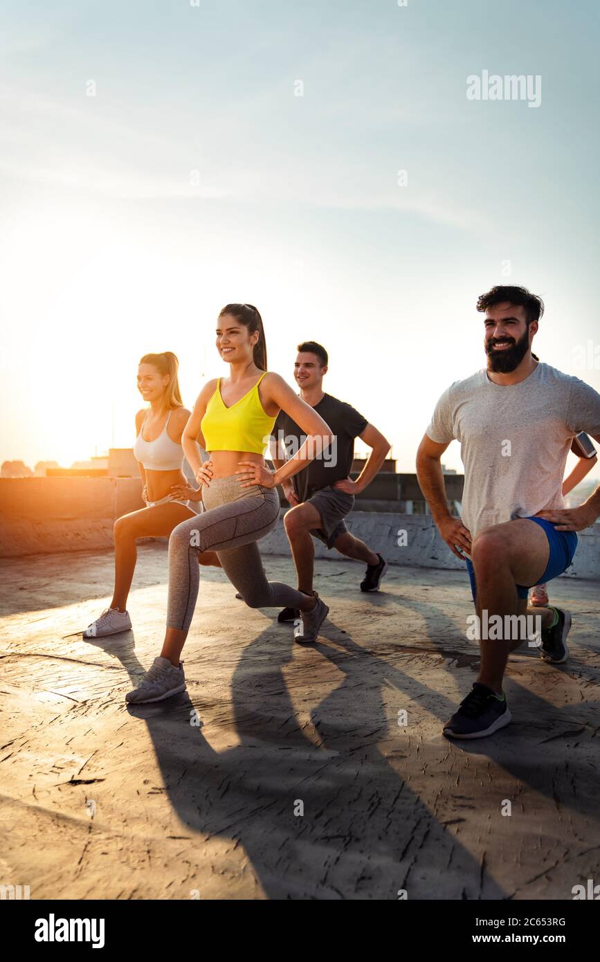 Portrait of smiling fit happy people doing power fitness exercise Stock ...