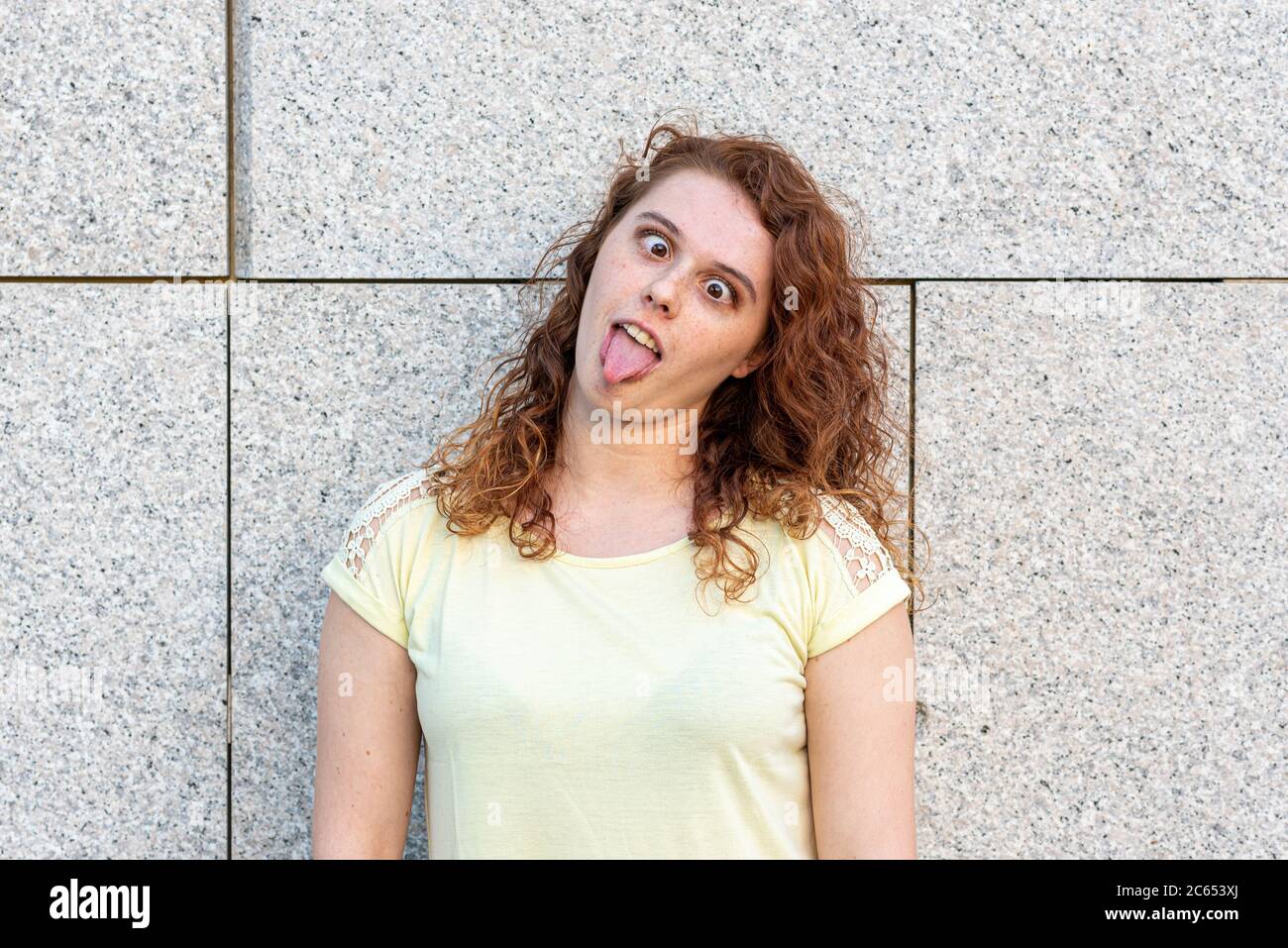 young girl with red hair is portrayed with funny, childish and stupid ...