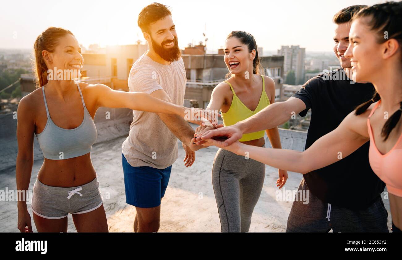 Group of happy fit people friends exercising together outdoor Stock ...