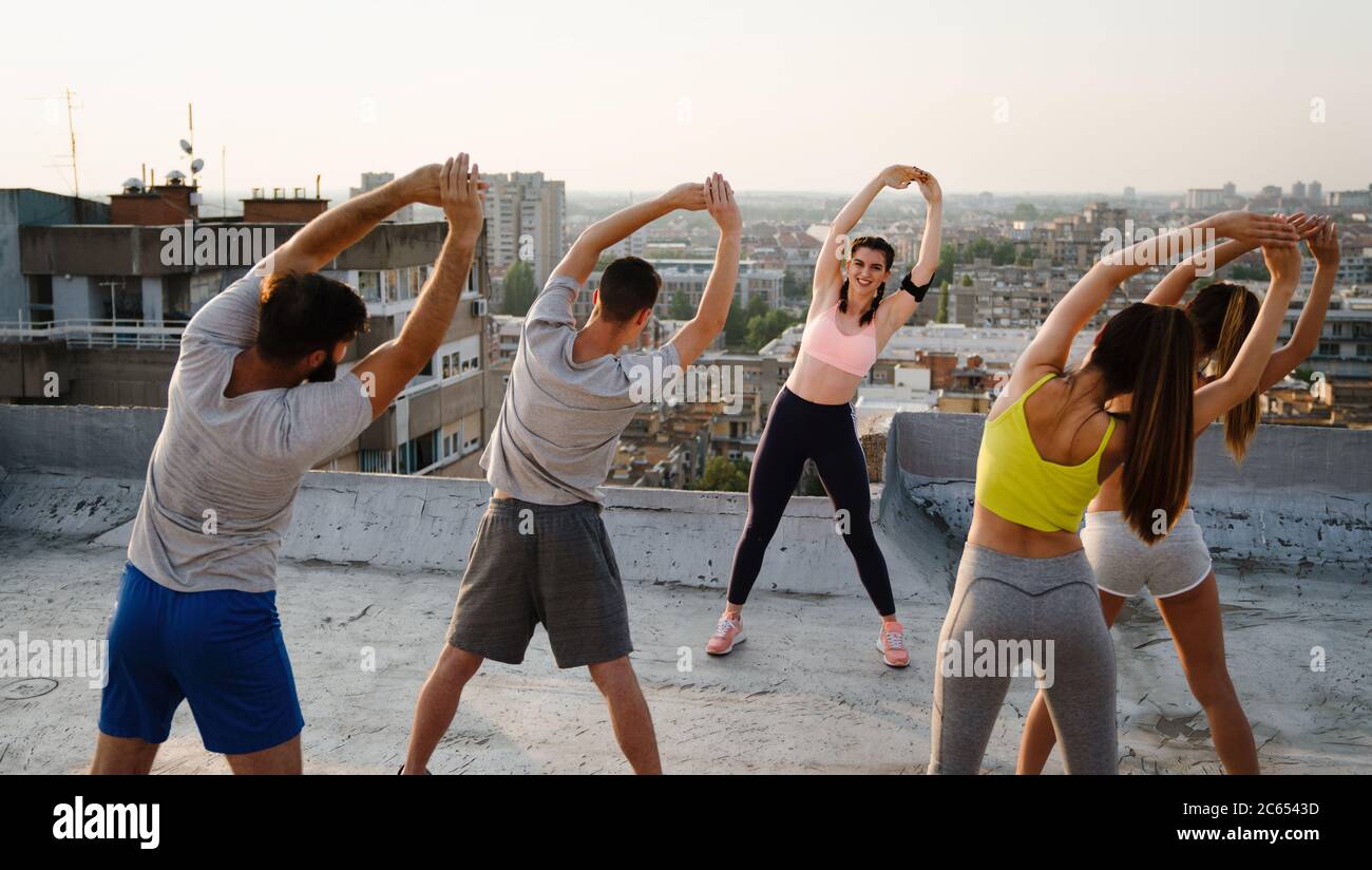 Group of fit healthy friends, people exercising together outdoor Stock ...