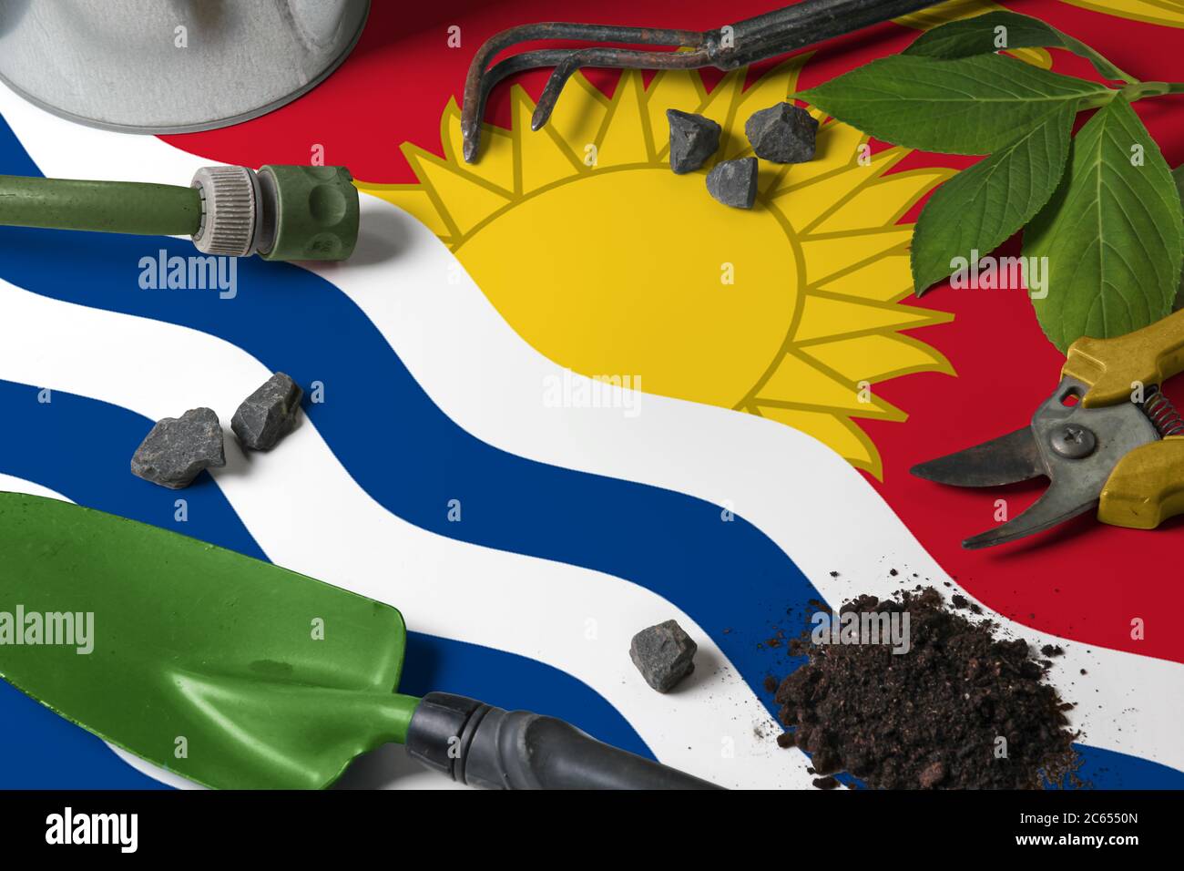 Kiribati flag with gardening tools background on table. Spring in the ...
