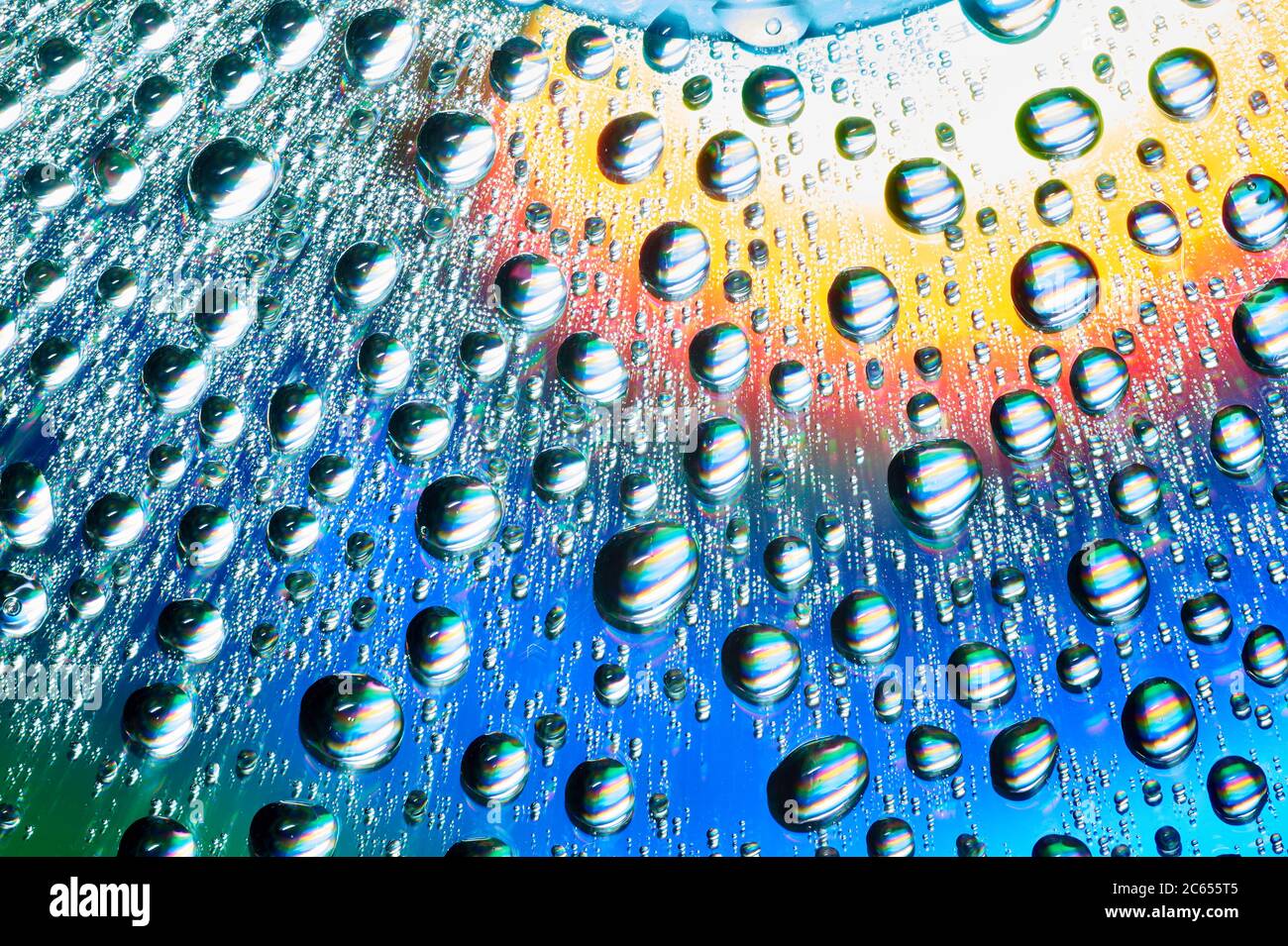 Macro of water drops on multicolor background Stock Photo - Alamy