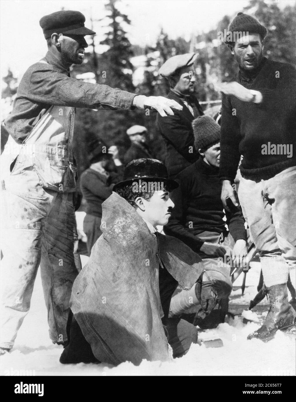 CHARLIE CHAPLIN in costume as the Tramp and Cinematographer ROLAND ...