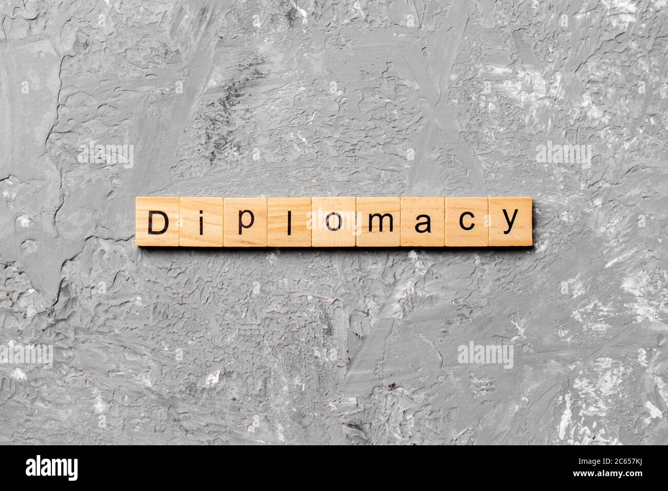 diplomacy word written on wood block. diplomacy text on cement table ...