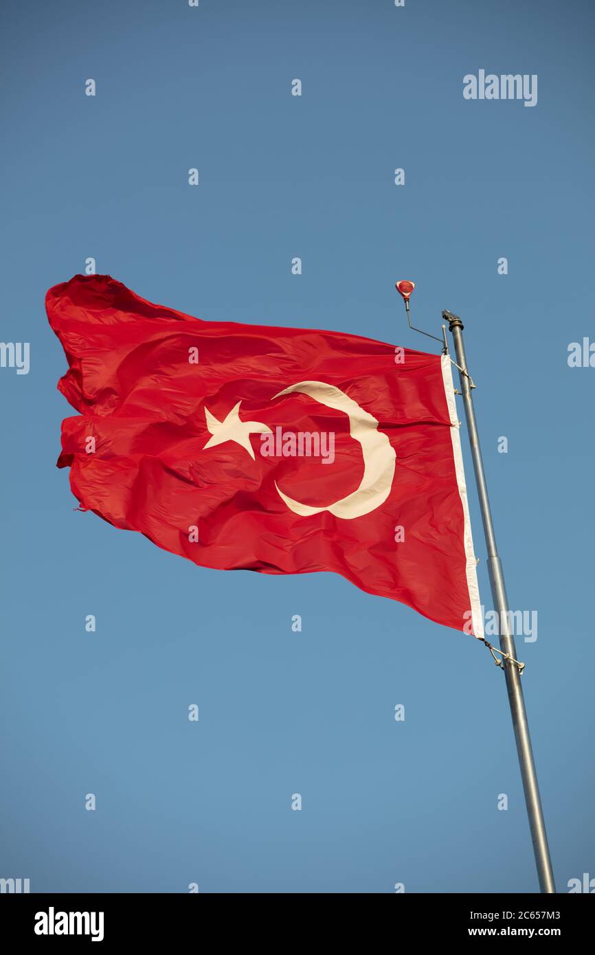 Turkish flag waving in blue sky Stock Photo - Alamy
