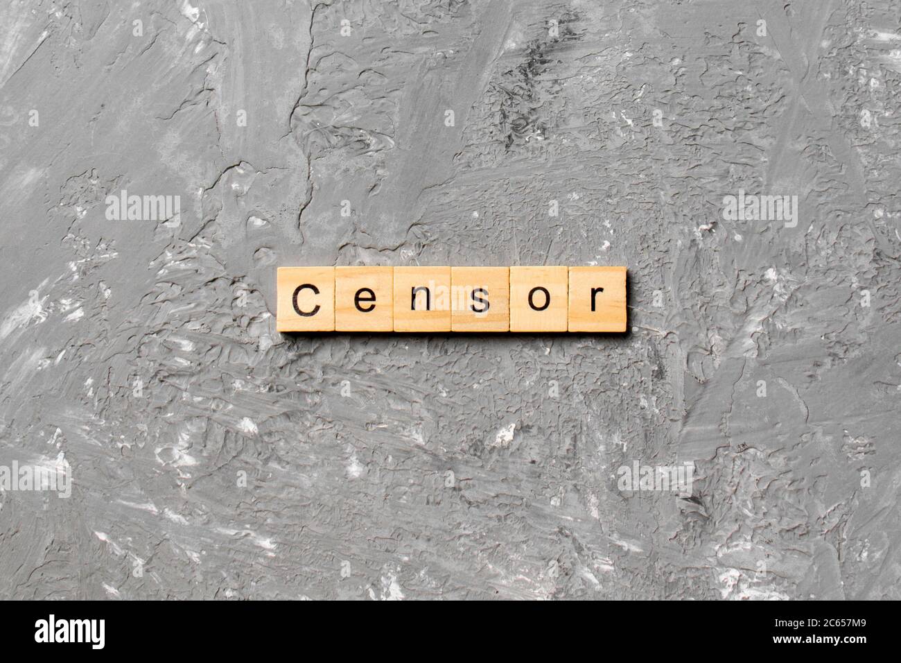 Censor word written on wood block. Censor text on cement table for your ...