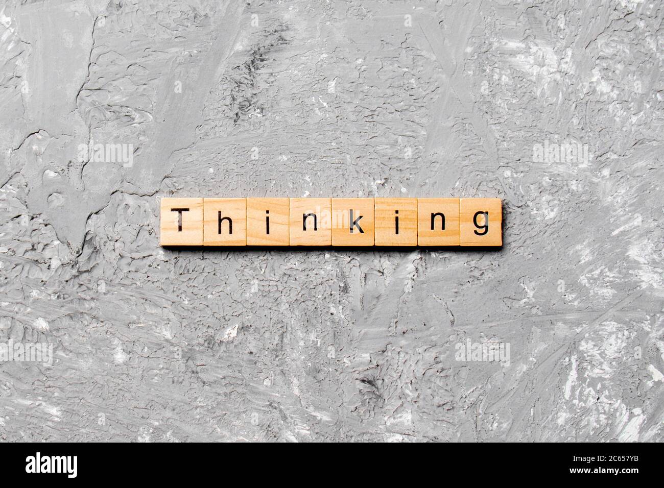 thinking word written on wood block. thinking text on cement table for your desing, concept ...