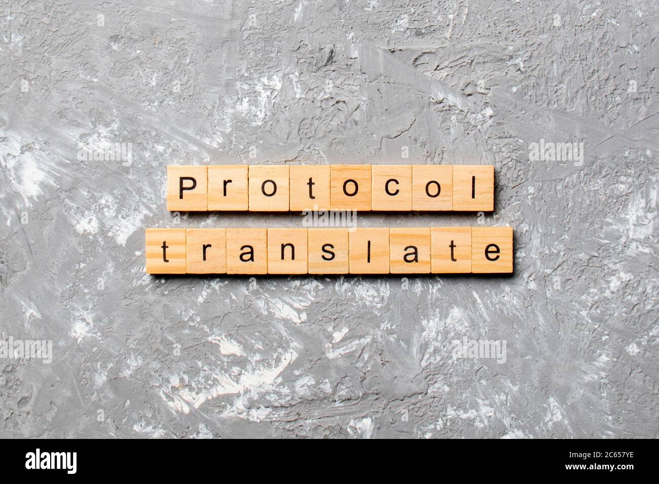 PROTOCOL translate word written on wood block. PROTOCOL translate text ...