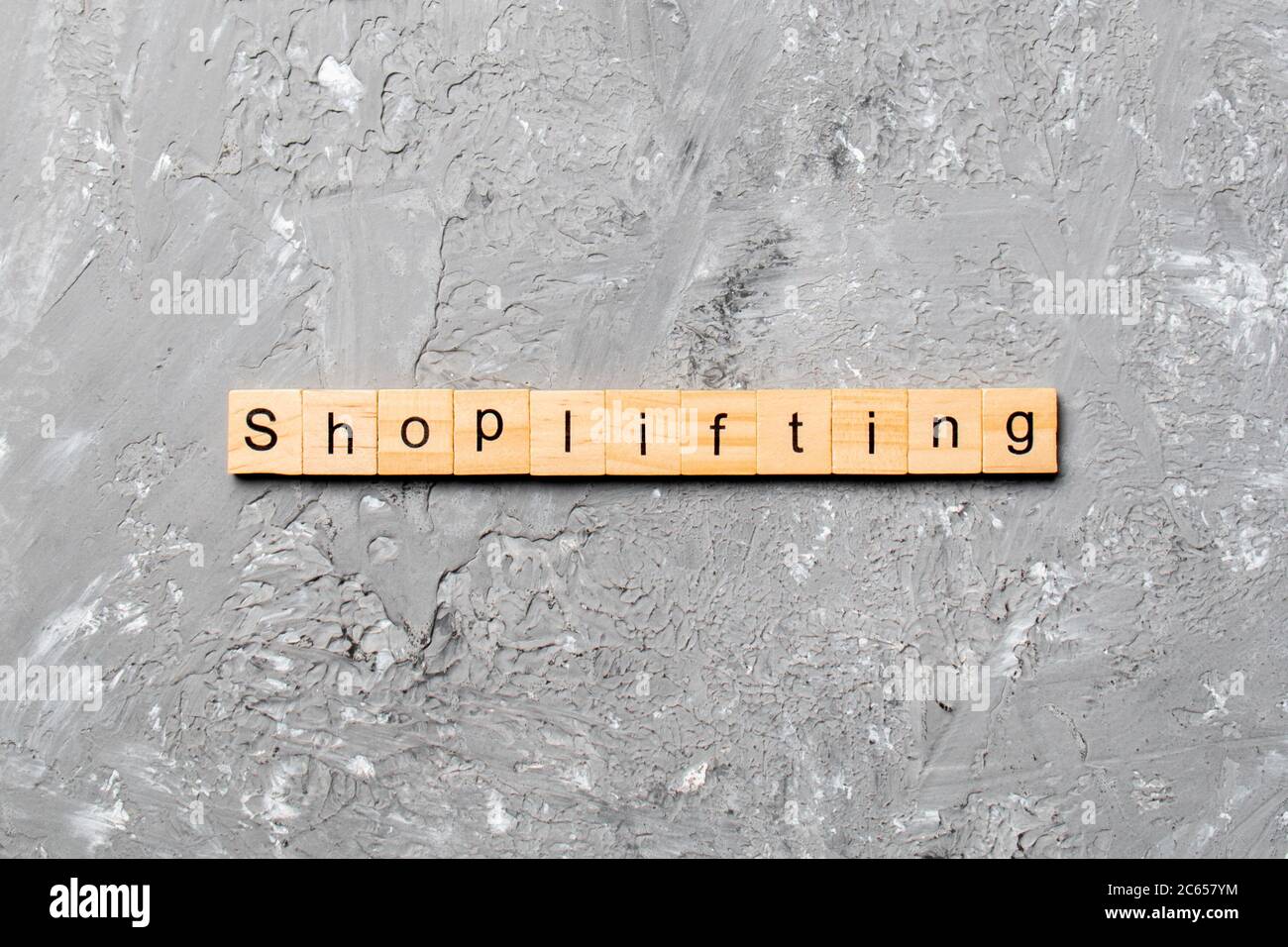 Shoplifting word written on wood block. Shoplifting text on cement ...
