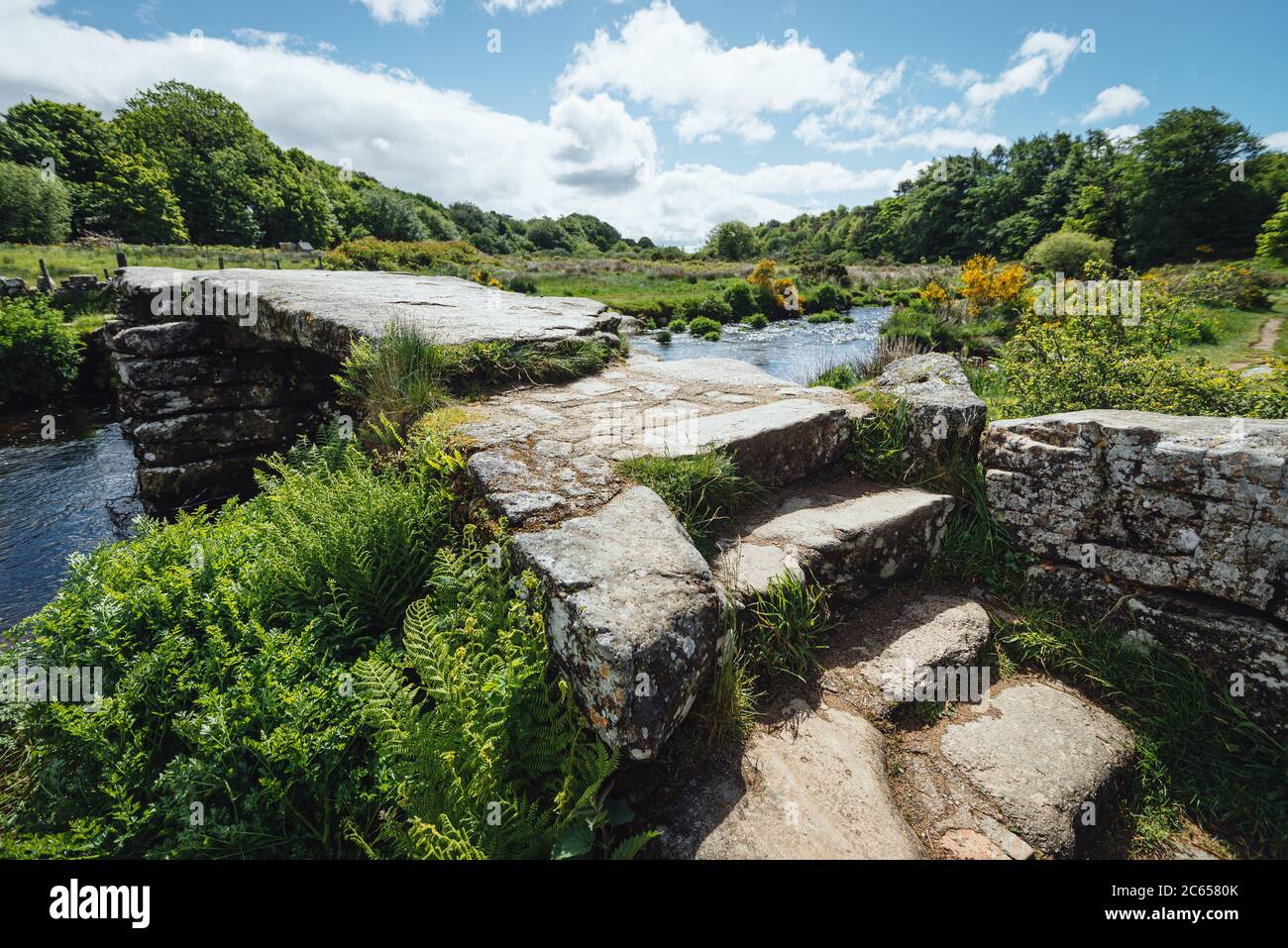 Postbridge village’s 13th century clapper bridge crossing the East Dar ...