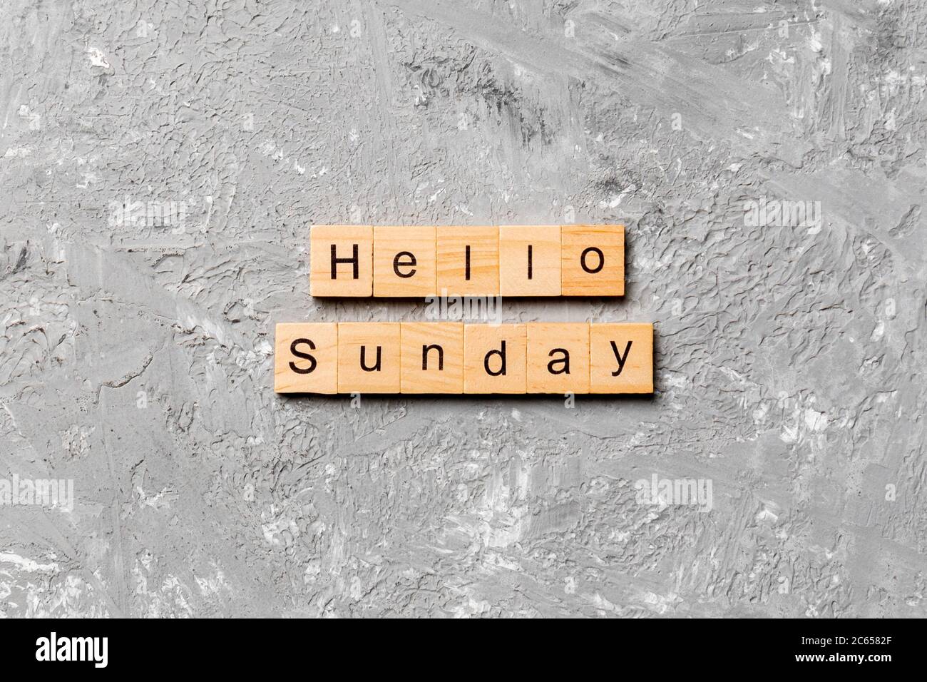 hello sunday word written on wood block. hello sunday text on cement ...