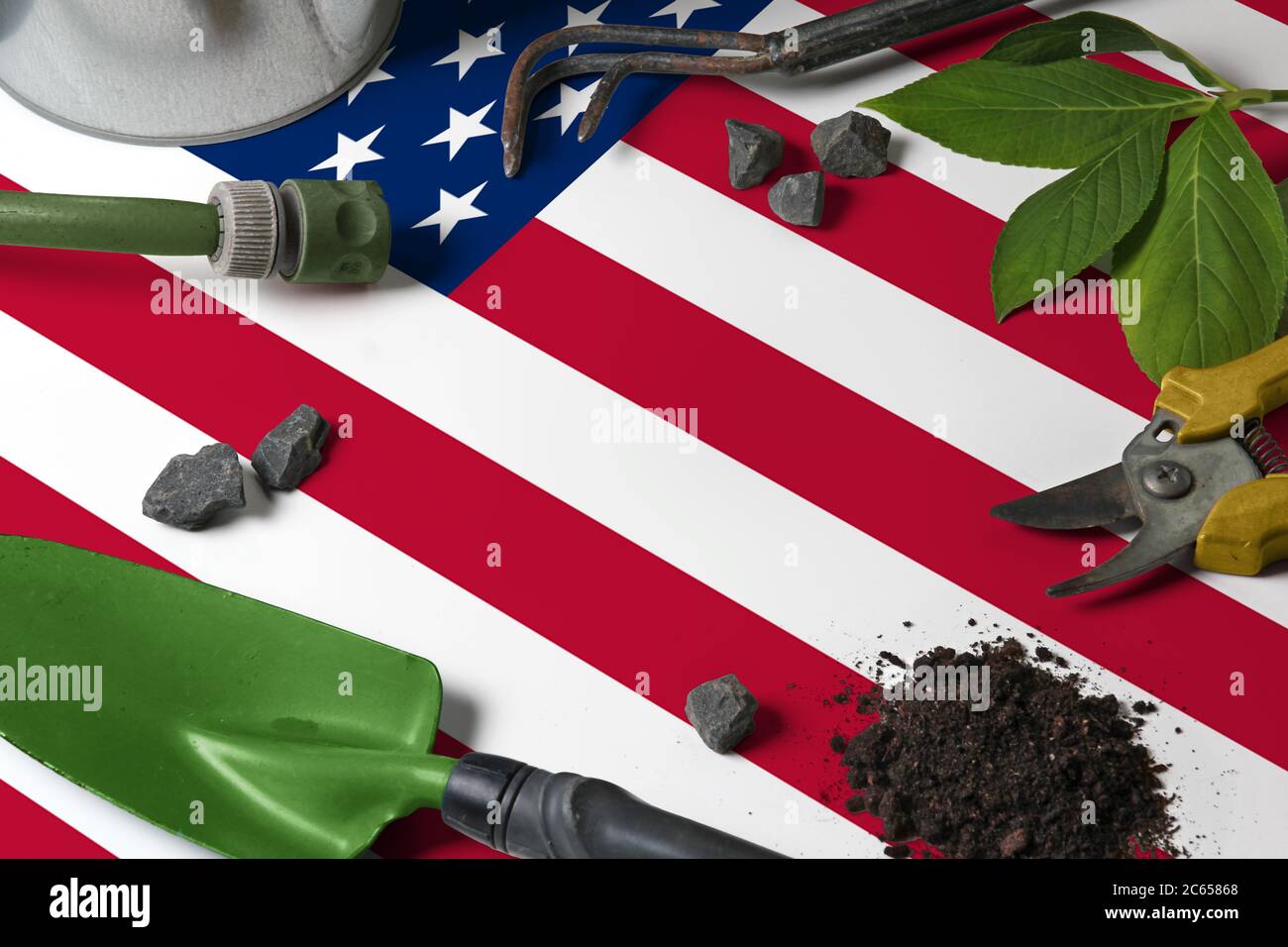 United States flag with gardening tools background on table. Spring in ...