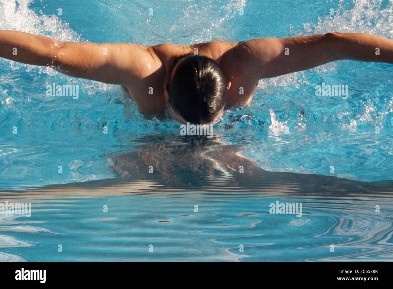 photo of a swimmer doing spring in swimming pool Stock Photo - Alamy