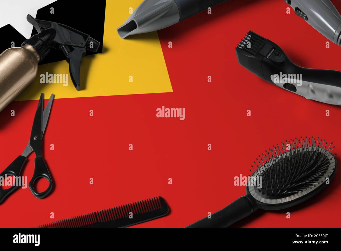 East Timor flag with hair cutting tools. Combs, scissors and ...