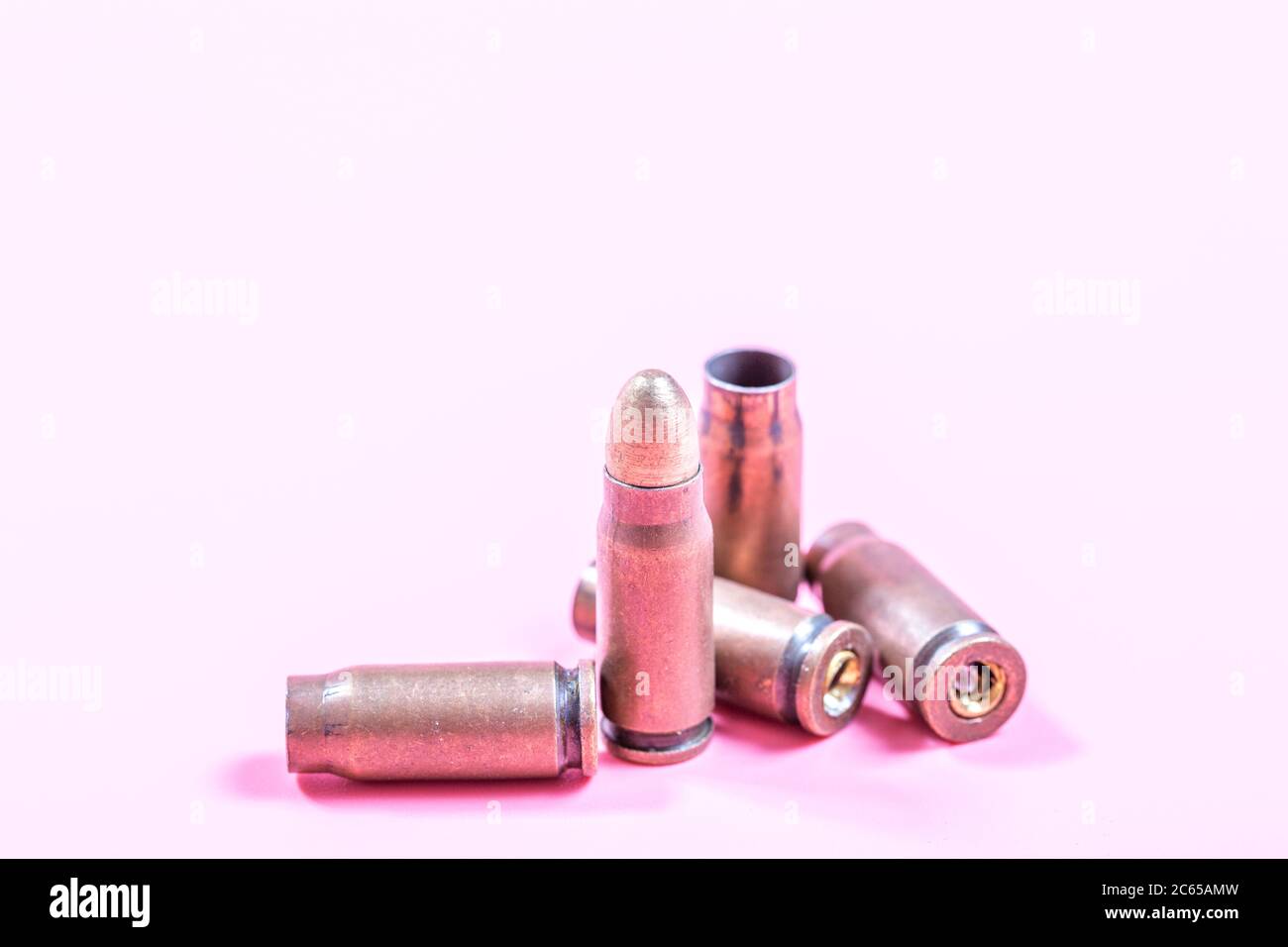 Bullet shell with pink background Stock Photo - Alamy