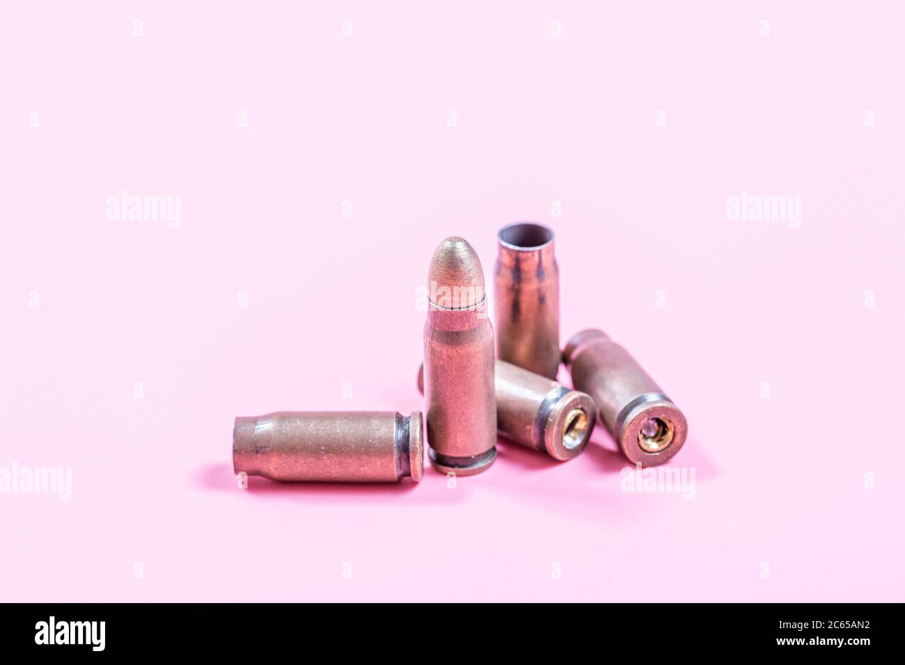 Bullet shell with pink background Stock Photo - Alamy