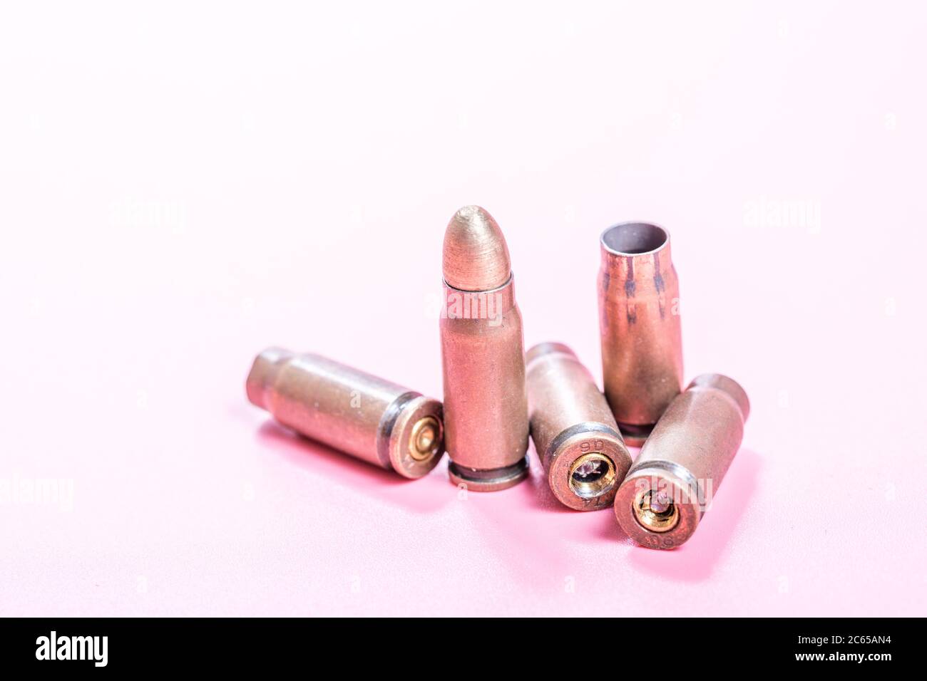Bullet shell with pink background Stock Photo - Alamy