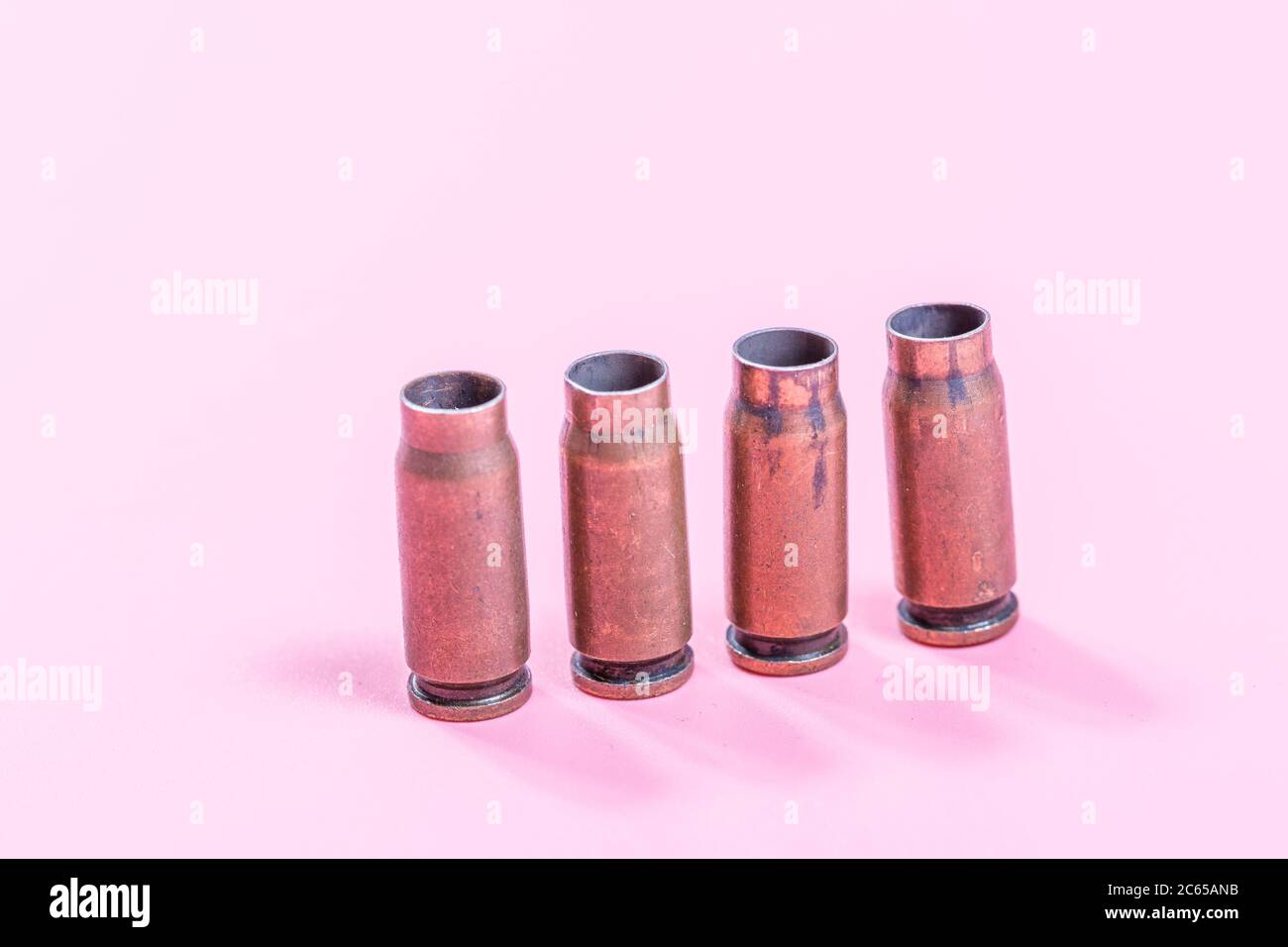 Bullet shell with pink background Stock Photo - Alamy