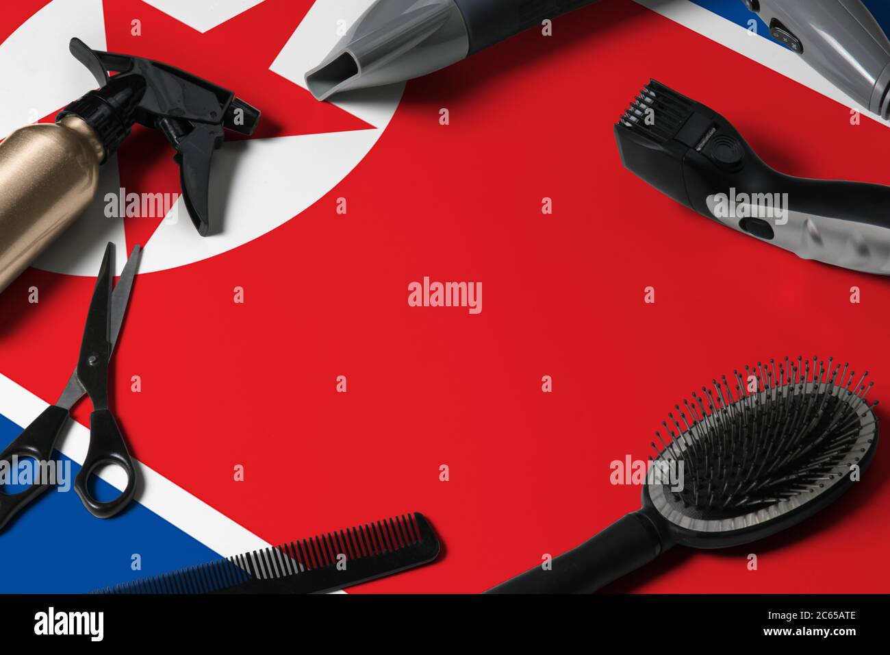 North Korea flag with hair cutting tools. Combs, scissors and ...