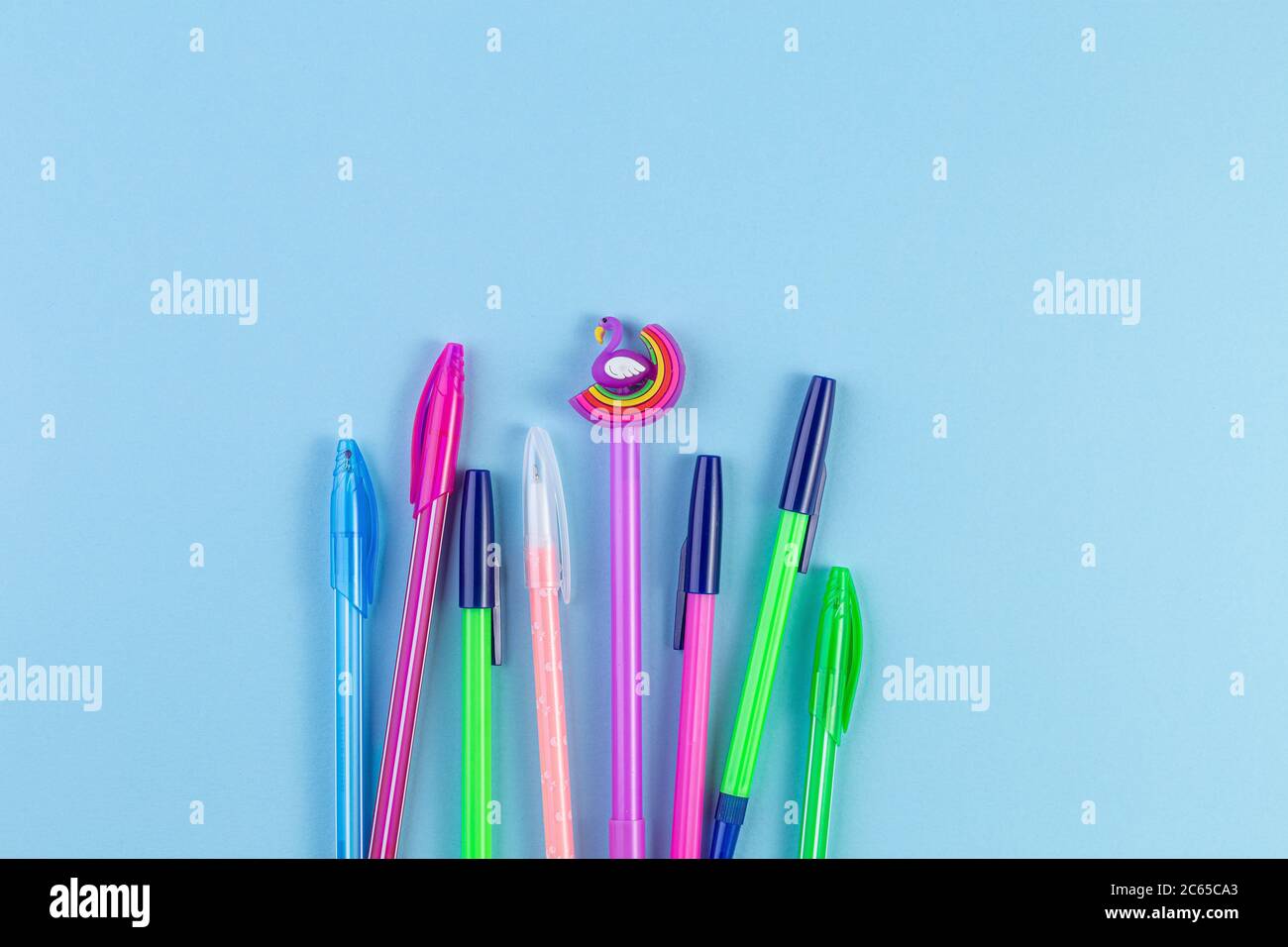 Set of colored pens on blue paper background with copy space. Flat lay ...