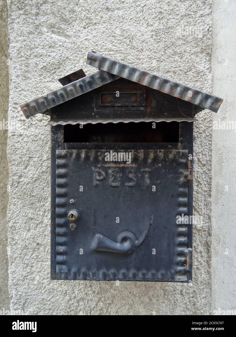 Old metallic post box located on a stone wall captured in Italy Stock ...