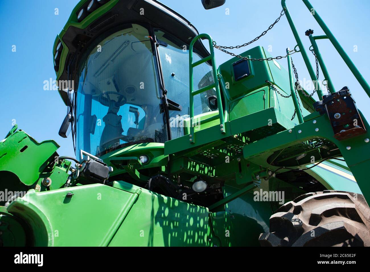 Professional modern tractor, combine at a field in sunlight at work ...