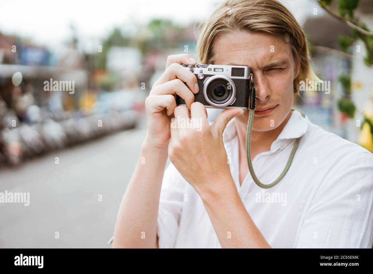 portrait of a man photographer with camera while on summer holiday ...