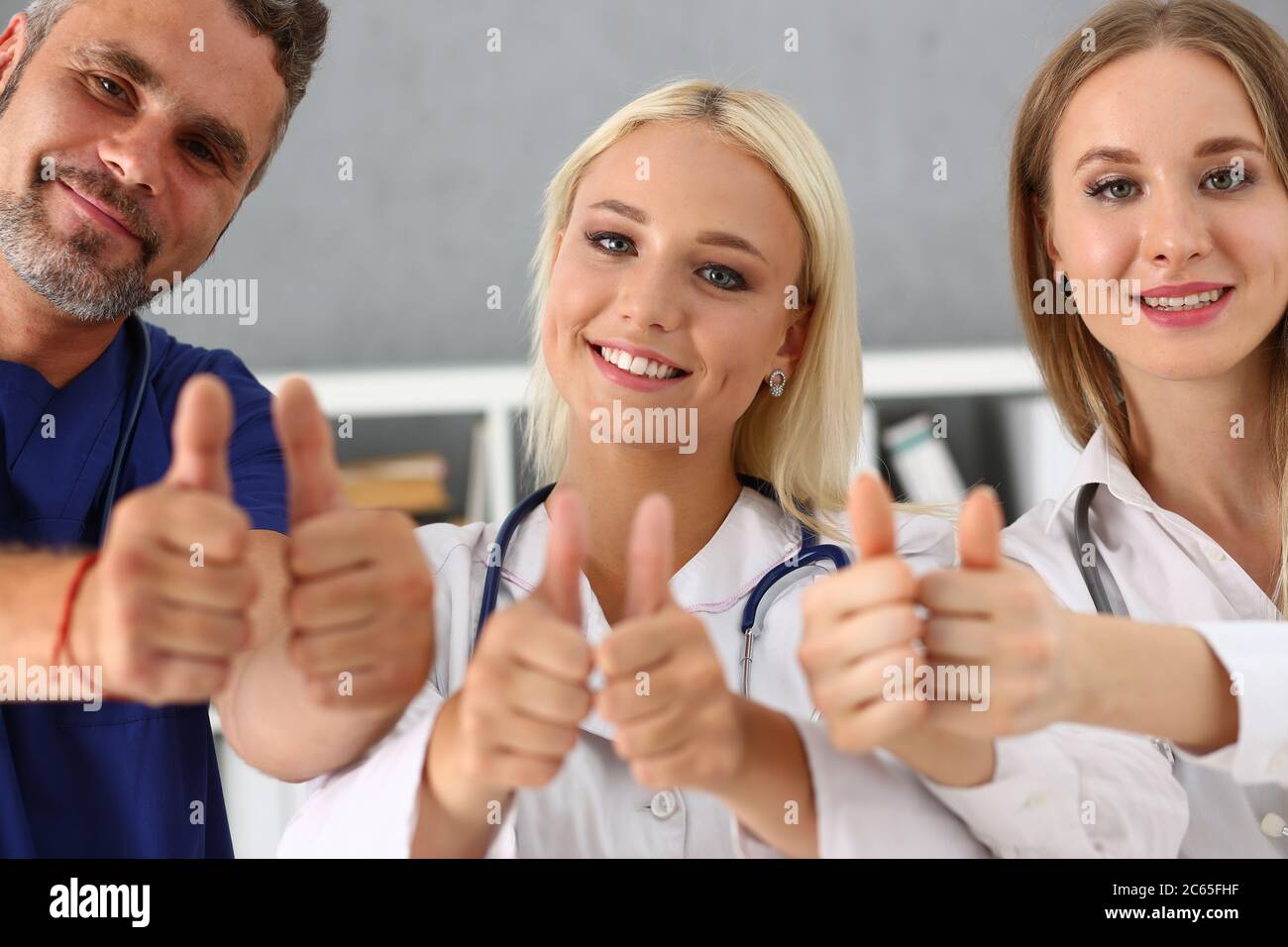 Smiling professional doctors are showing Ok signs Stock Photo - Alamy