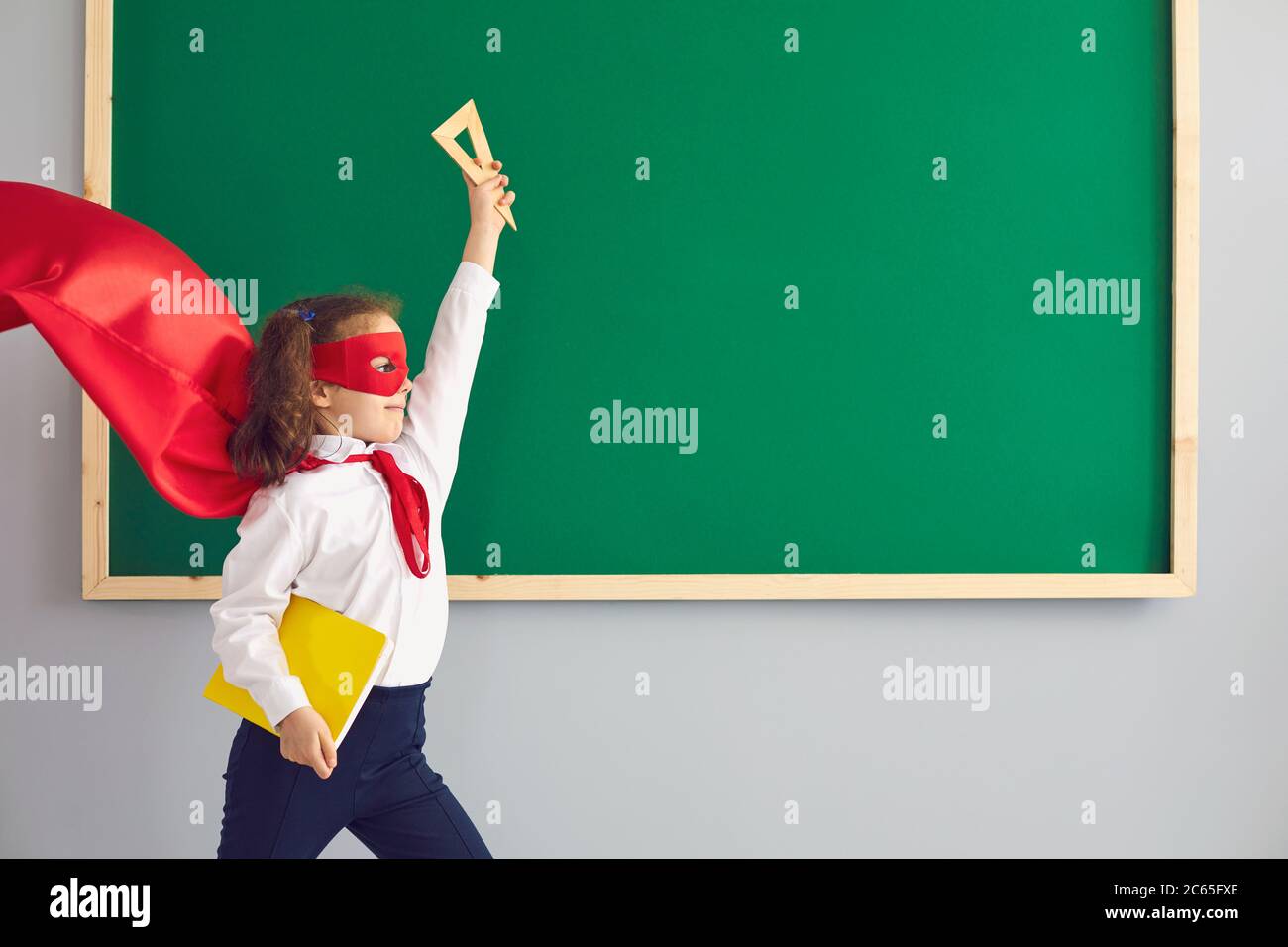 Back school. Cute brave girl in superhero costume near chalkboard at ...