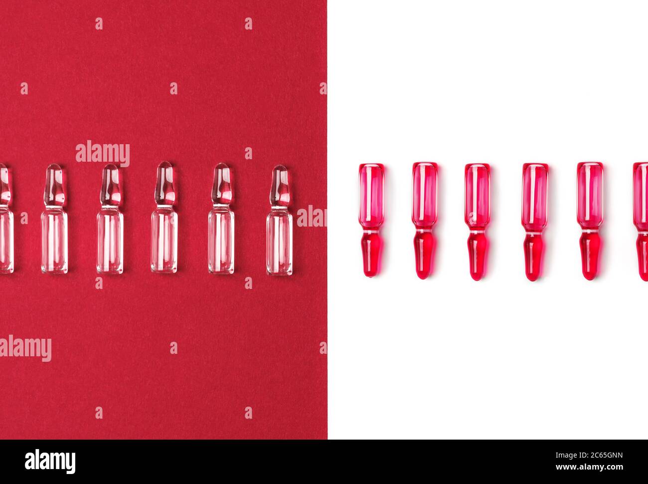 Line of ampules for injections with red and transparent liquid on ...