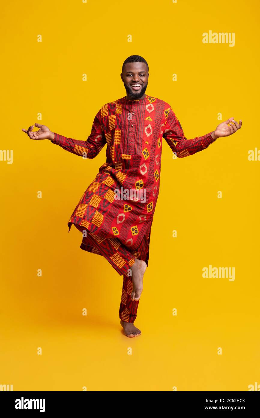 Happy african man standing on one leg, meditating Stock Photo - Alamy