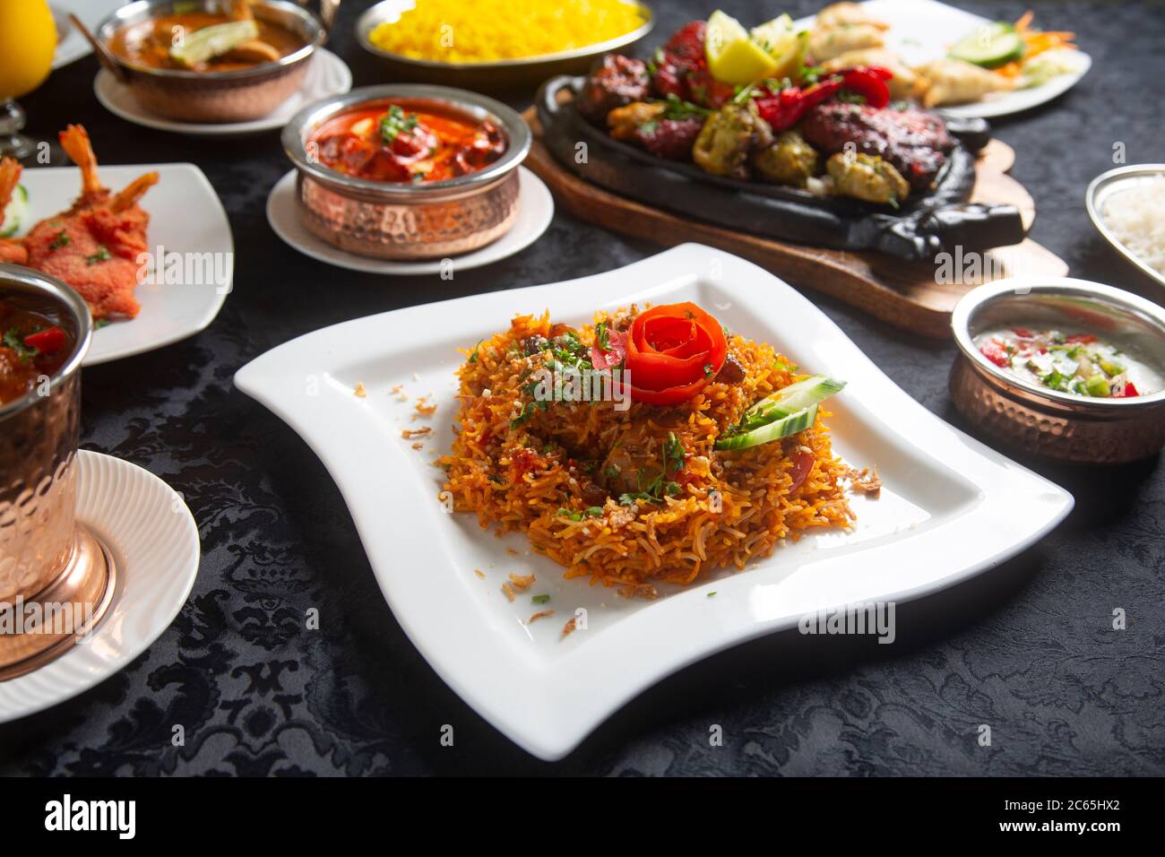 Table with typical Indian dishes, Biryani, chicken curry, tandoori ...