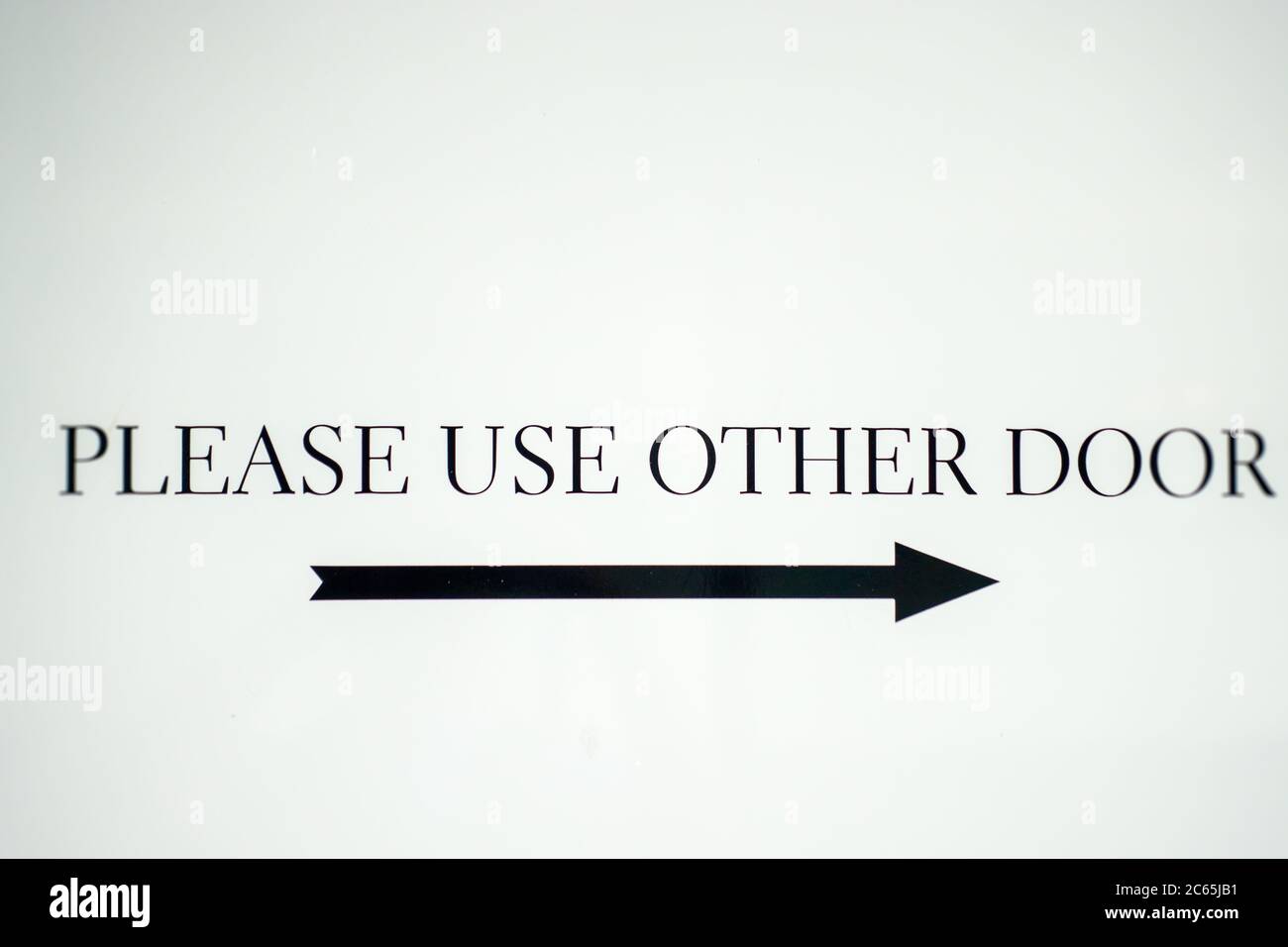 Please use other door sign Stock Photo - Alamy