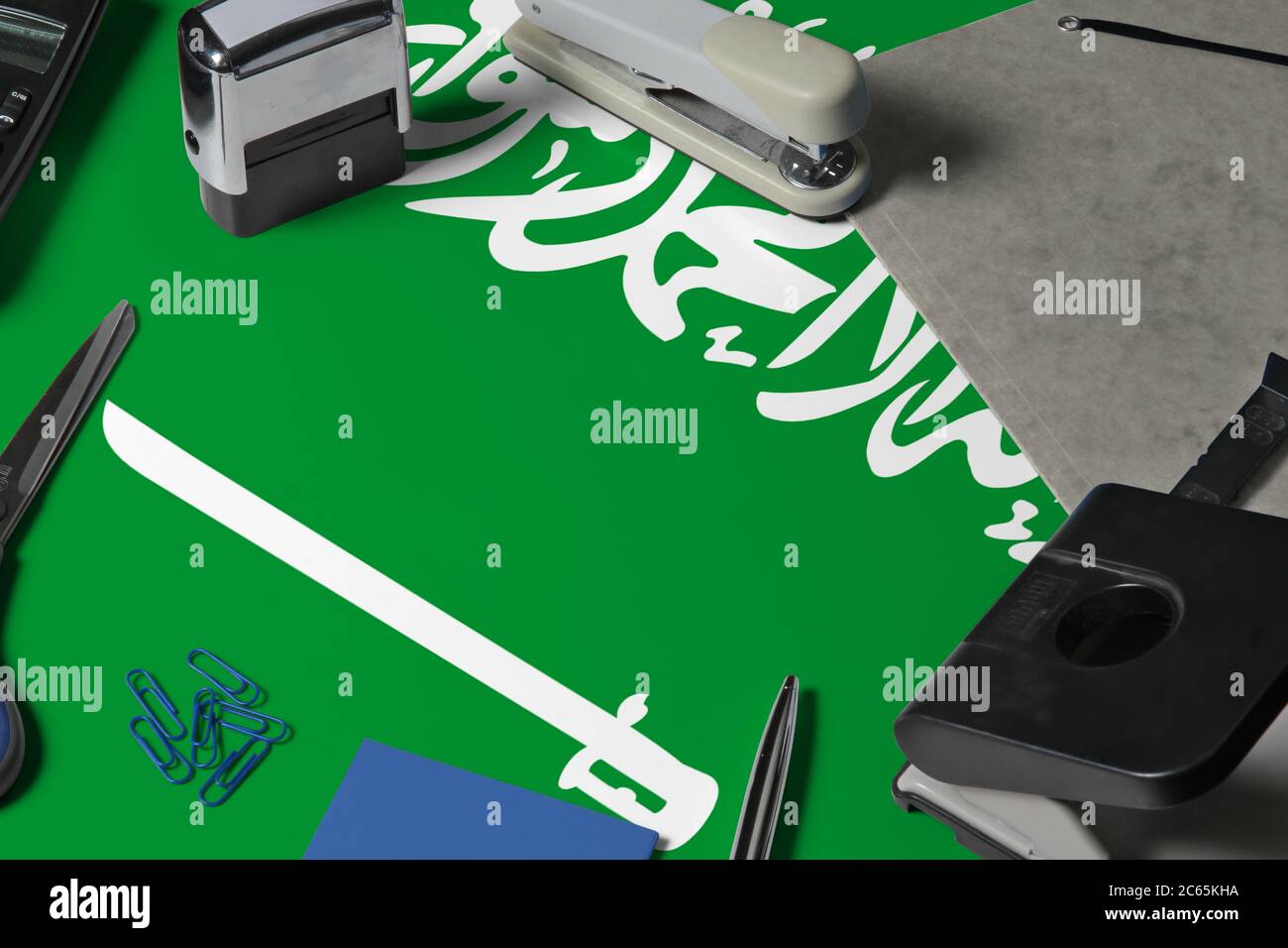 Saudi Arabia flag with office clerk workplace background. National ...