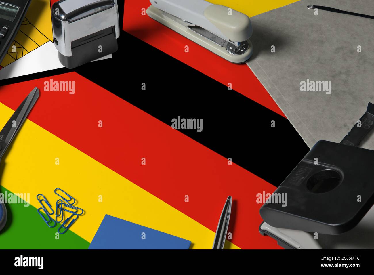 Zimbabwe flag with office clerk workplace background. National ...