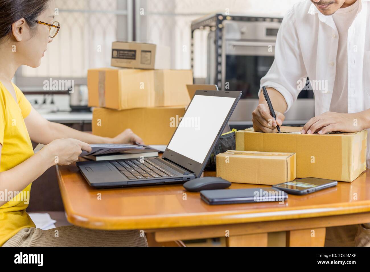 Business couple hand writing address on parcel box work from home Stock ...